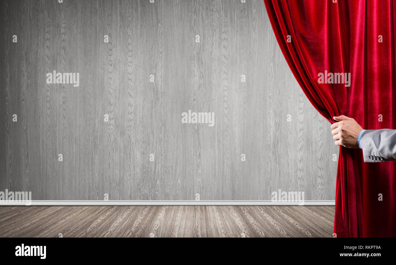 Concrete wall behind drapery curtain and hand opening it Stock Photo ...