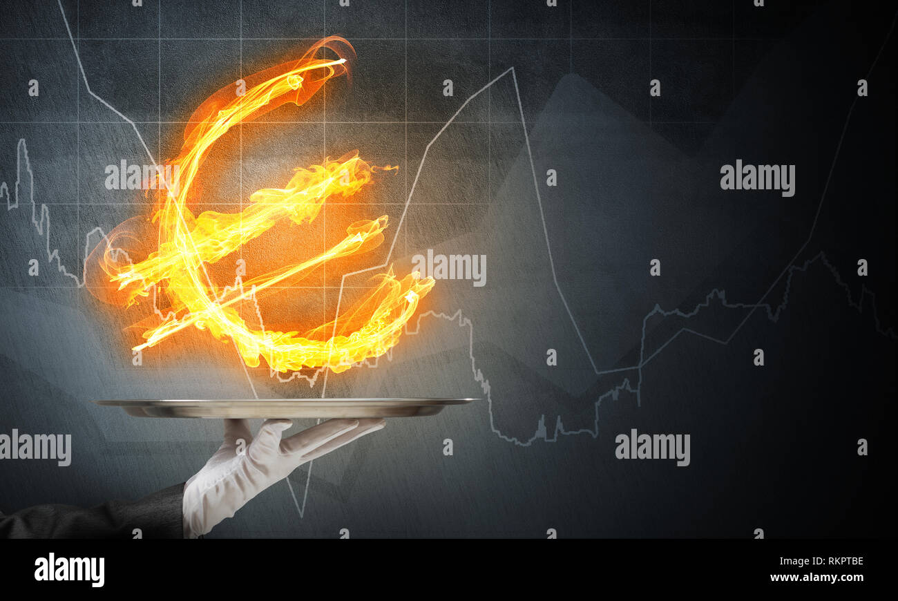 Hand of waitress presenting flaming euro sign Stock Photo - Alamy