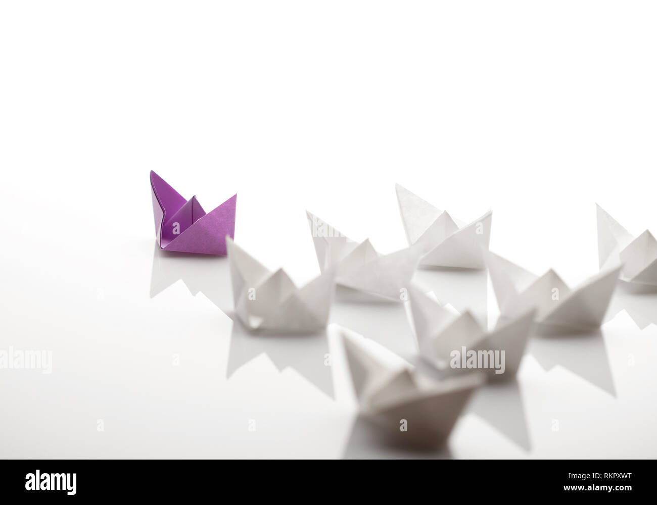 Leadership concept using blue paper ship among white. Leader concept ...