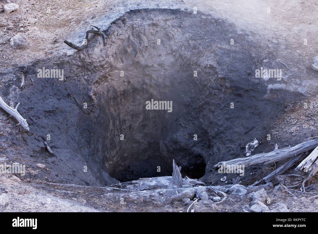An opening in ground with traces of high temperatures around it Stock ...
