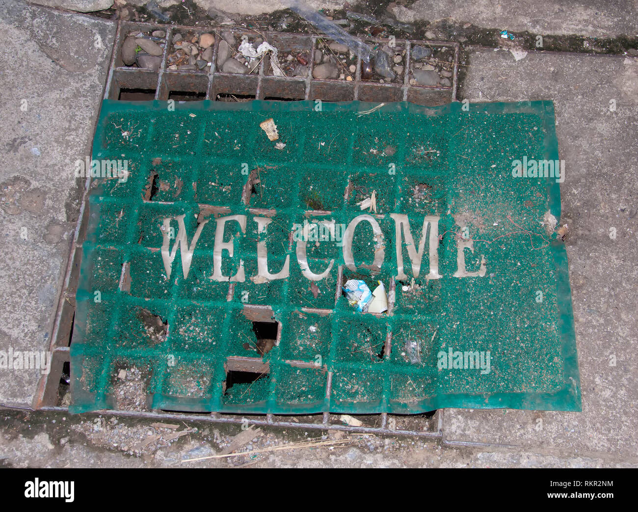 Old broken doormat with the imprint Welcome Stock Photo - Alamy