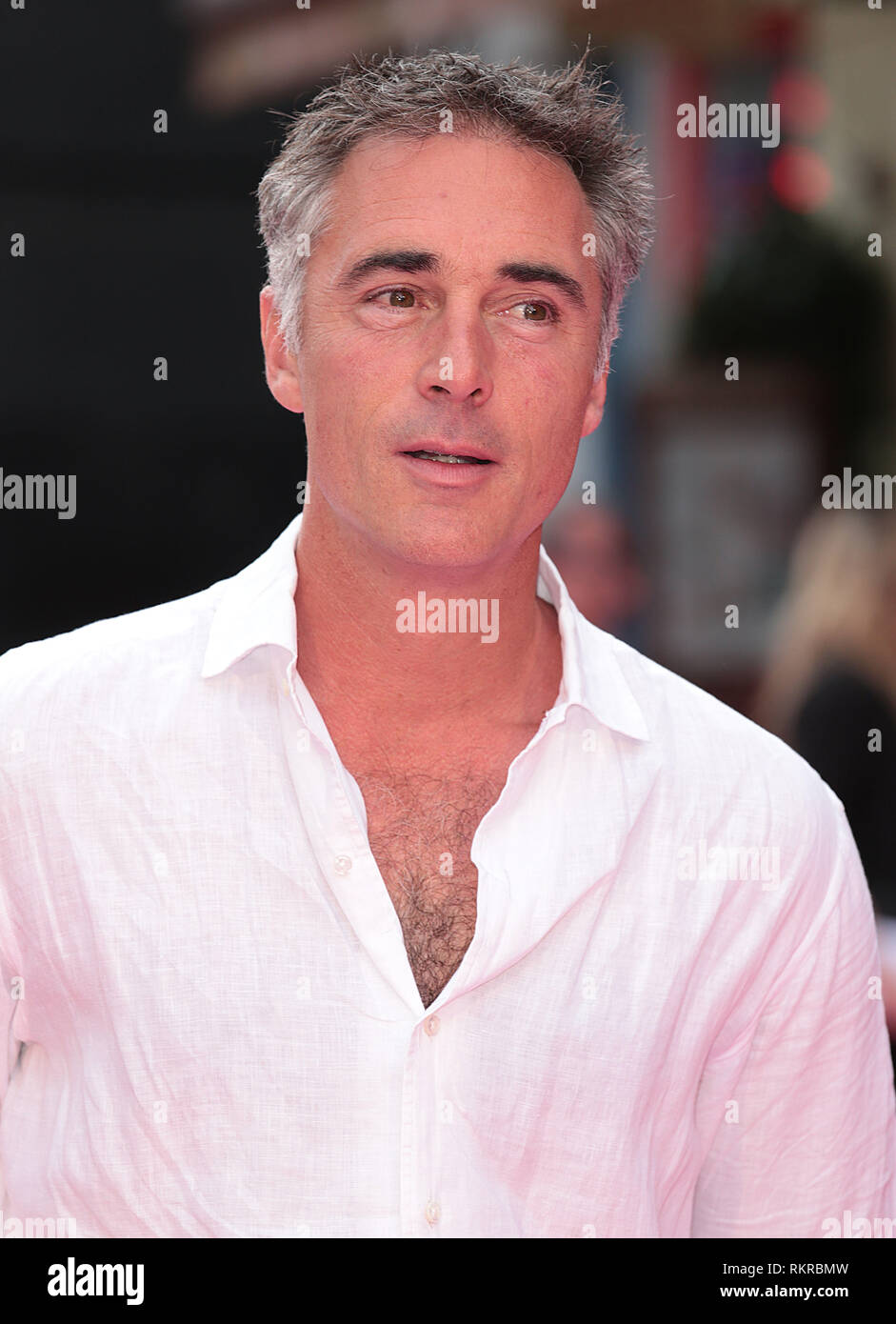 Greg Wise arrives on the Pink Carpet the World Premiere of 'Walking On Sunshine' at Vue West End ...