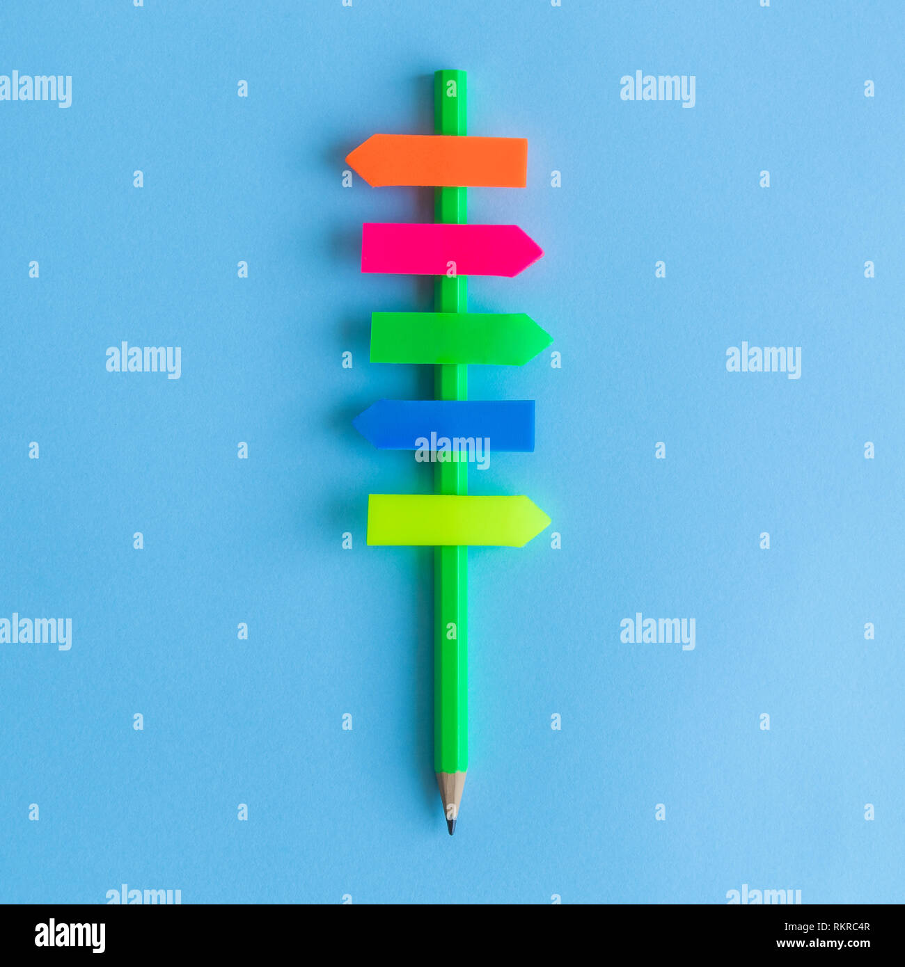 Flat lay of directions sign made of pencil and colorful blank sticky ...