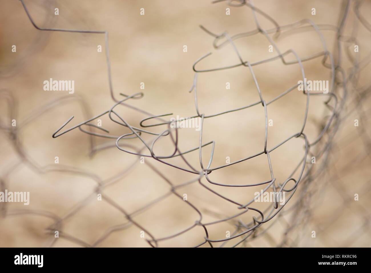 Torn barbed wire bent. Damaged fence. Macro photo. Selective focus ...