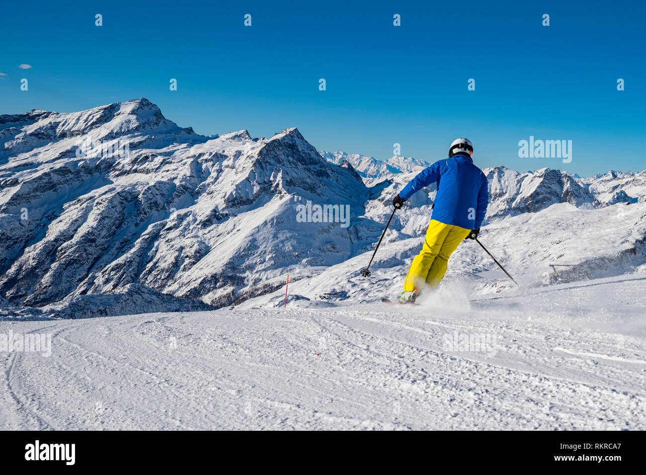 Skier in the alps Stock Photo - Alamy