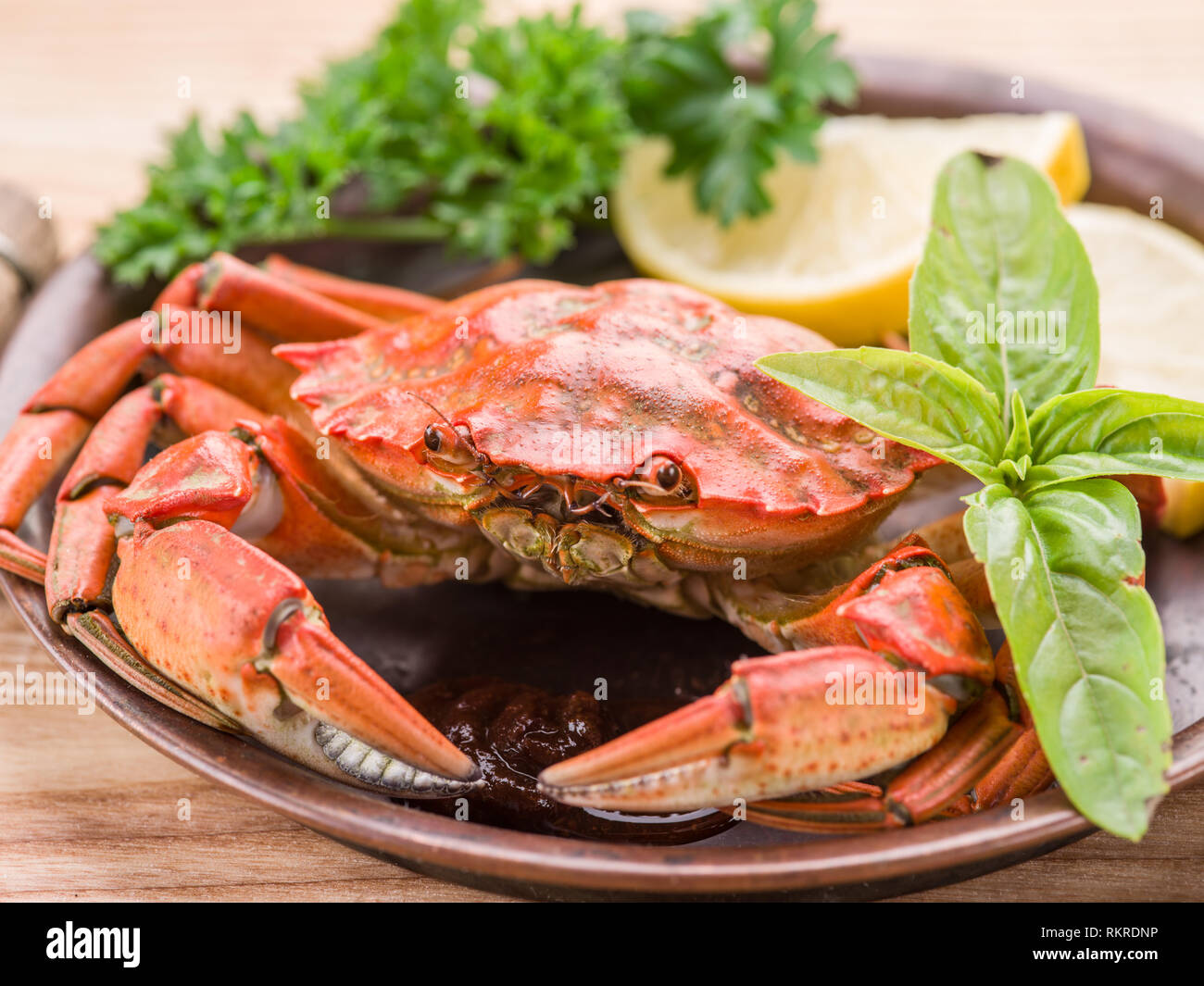 Seafood dish - cooked crab with lemon and herbs Stock Photo - Alamy
