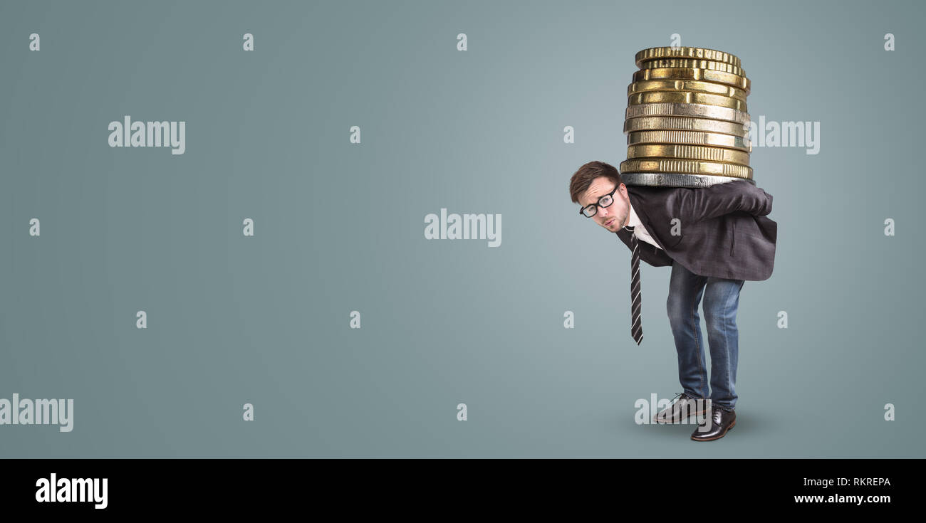 Businessman carrying a giant stack of coins on his back Stock Photo - Alamy