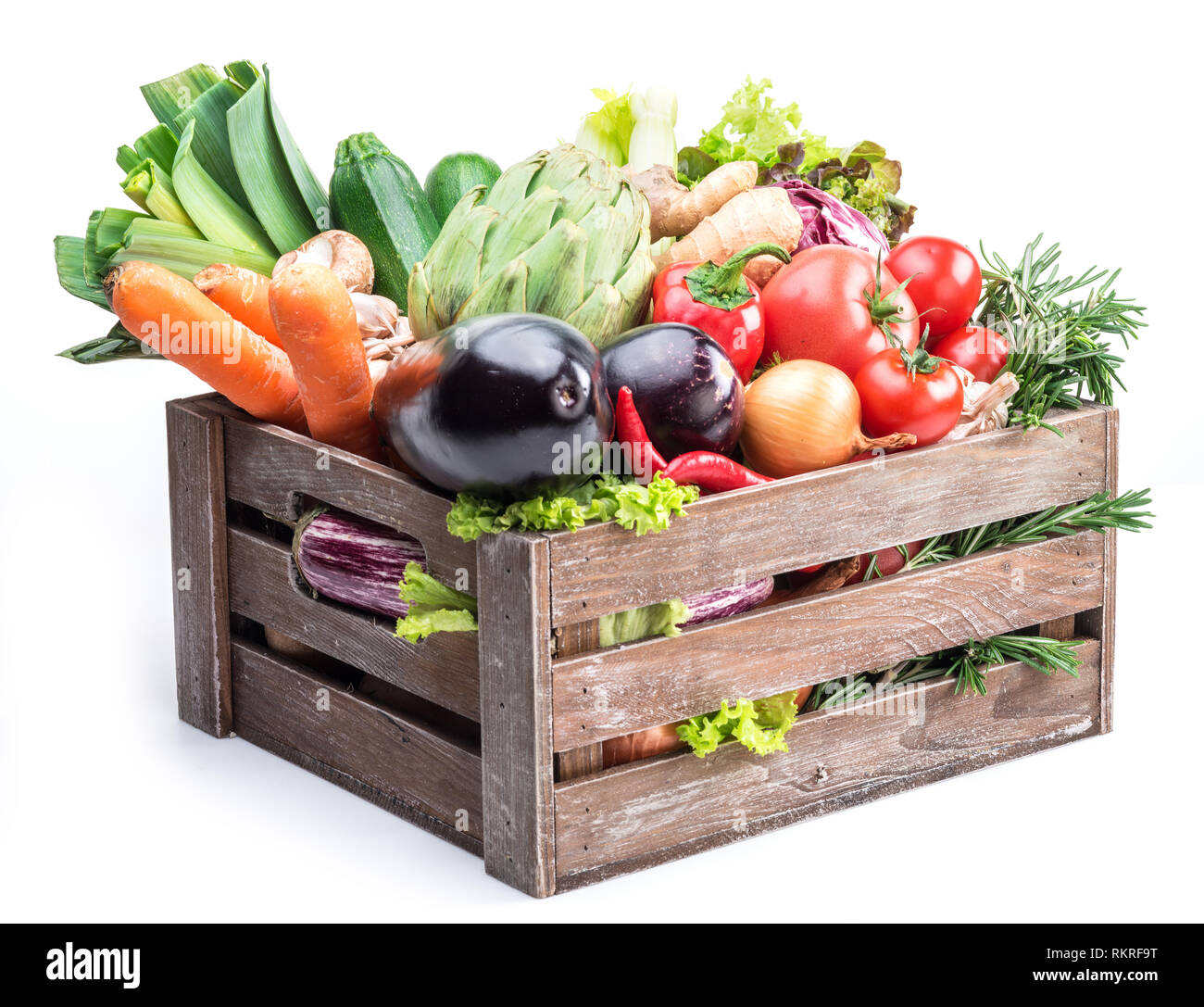 Fresh multi-colored vegetables in wooden crate. White background Stock ...