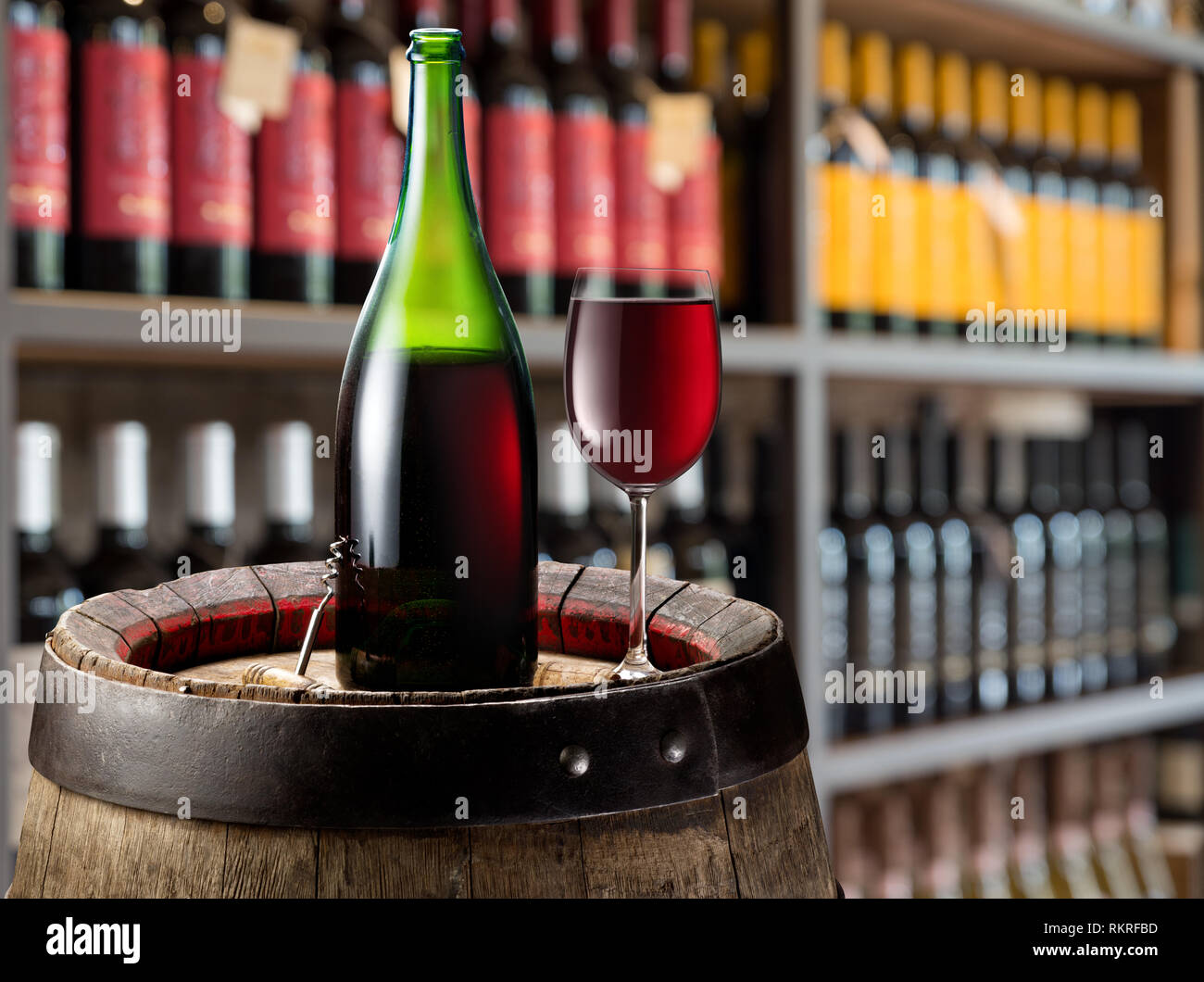 Wine bottle and glass of red wine on wooden cask. Wine shelves at the ...