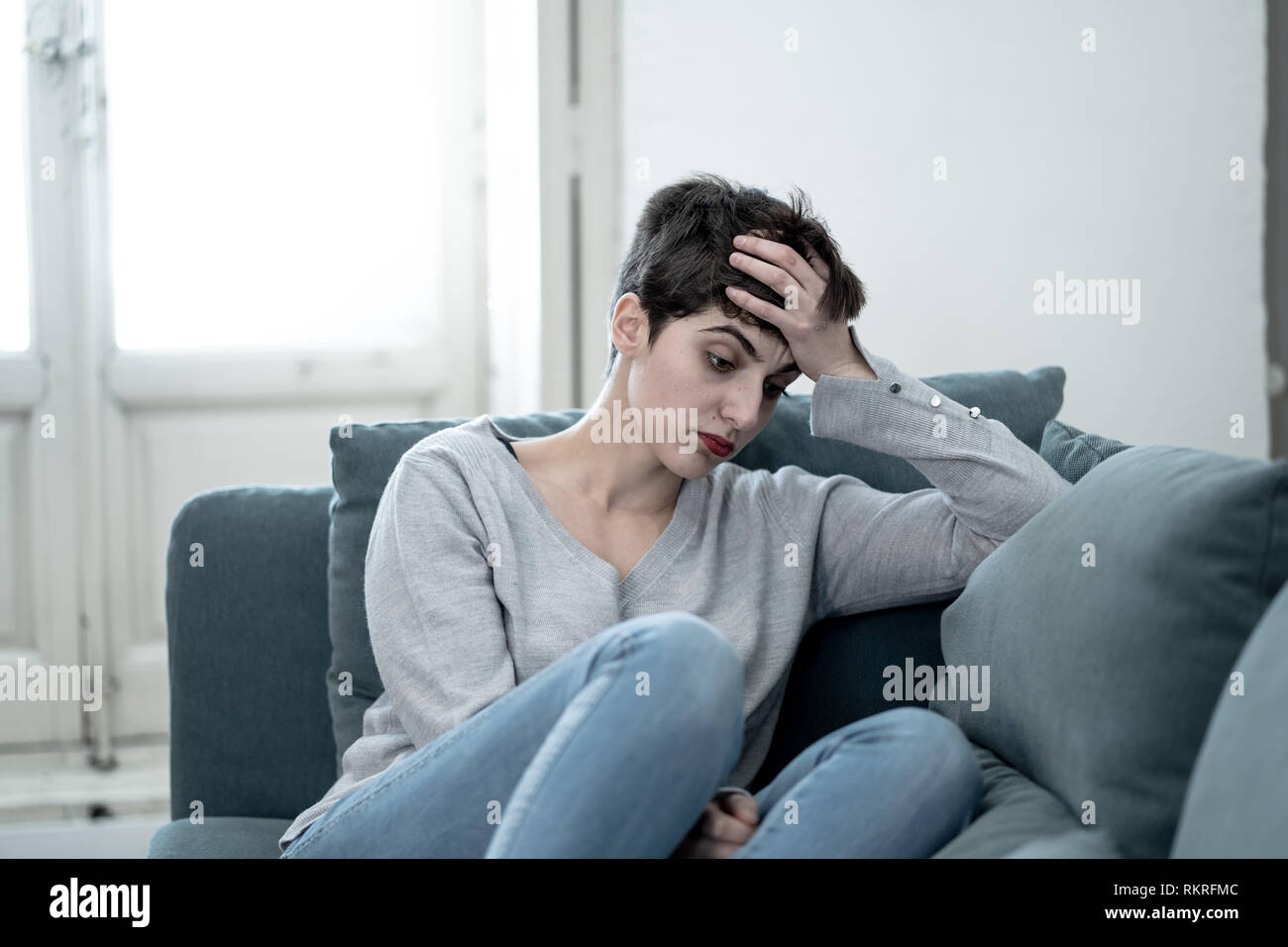 Portrait of Beautiful desperate and depressed young woman on sofa ...