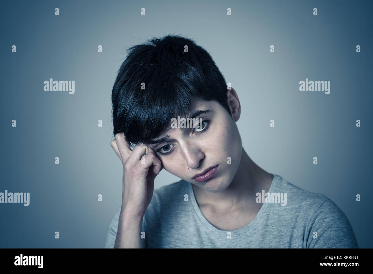Close up portrait of beautiful young woman with sad face looking ...