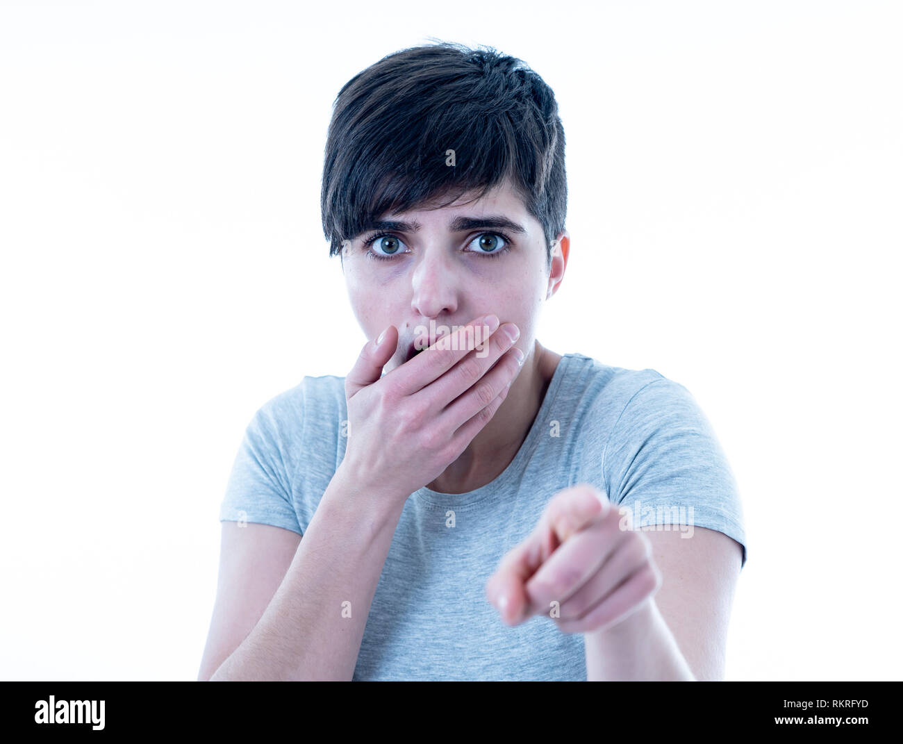 Close up portrait of scared and shocked young woman pointing at ...