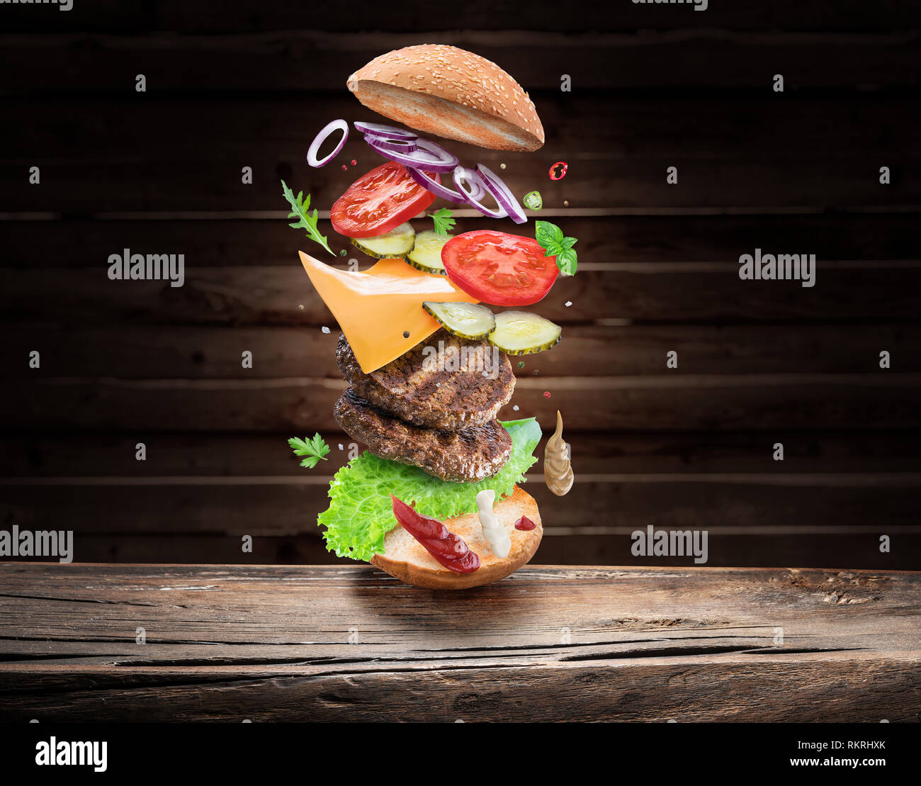 Hamburger ingredients falling down one by one to create a perfect meal ...