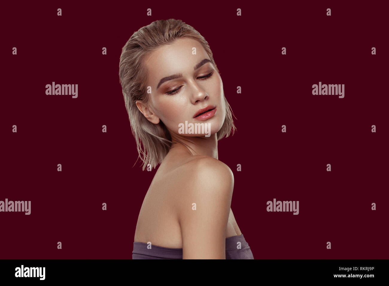 Slim model showing her open shoulders while posing for magazine Stock ...