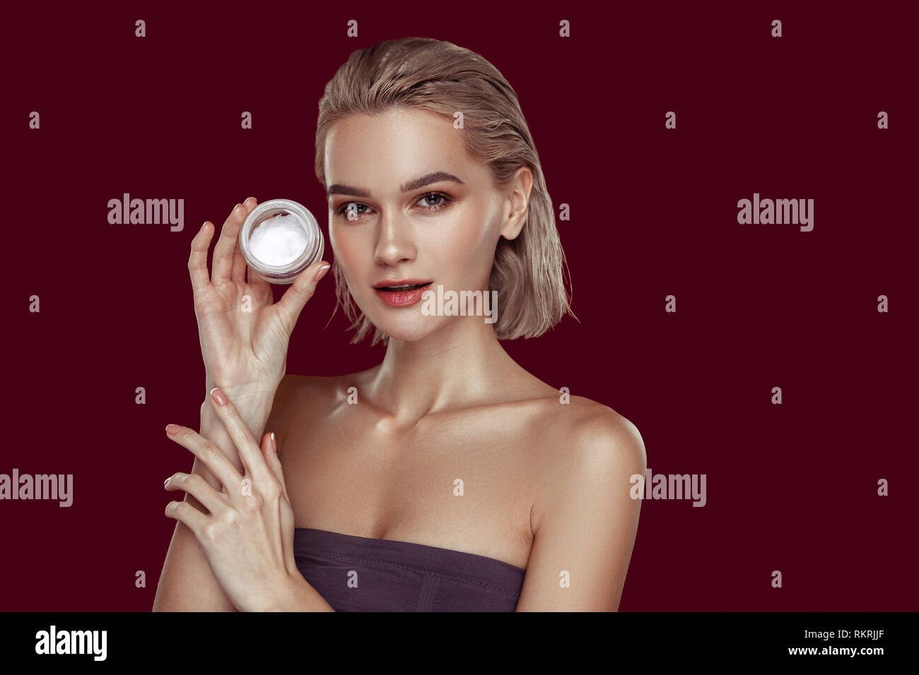 Photo model holding face cream participating in promotion campaign ...