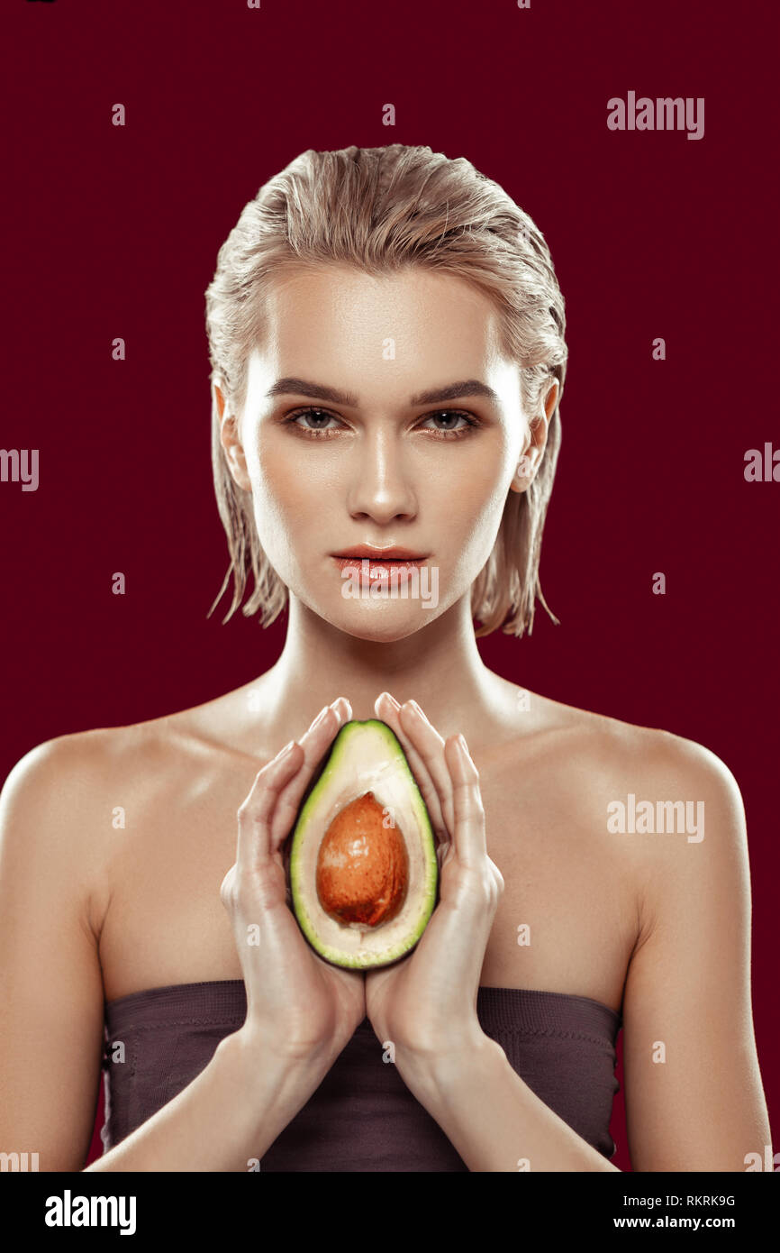 Slim professional model showing avocado posing for food magazine Stock ...