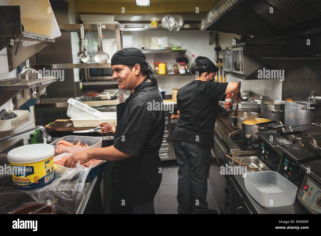 Staff working in a restaurant kitchen in Valencia, Spain Stock Photo ...