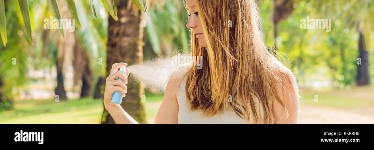 Woman spraying insect repellent on skin outdoor BANNER, long format ...