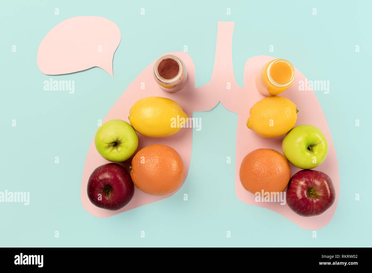 Detox food selection from fresh fruits in paper human lungs on blue ...