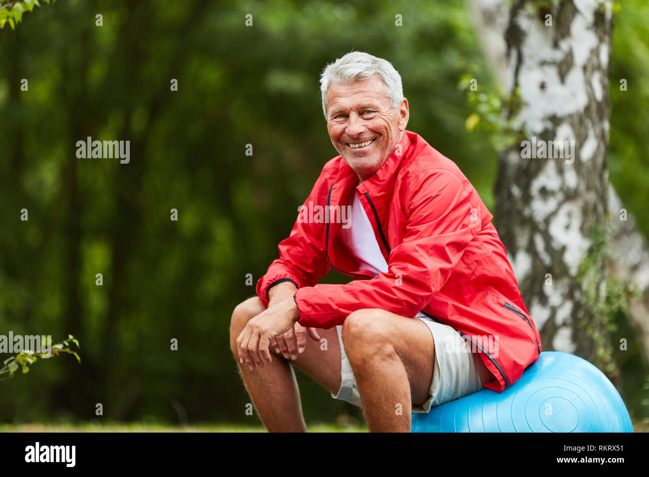 Man on gym ball hi-res stock photography and images - Alamy