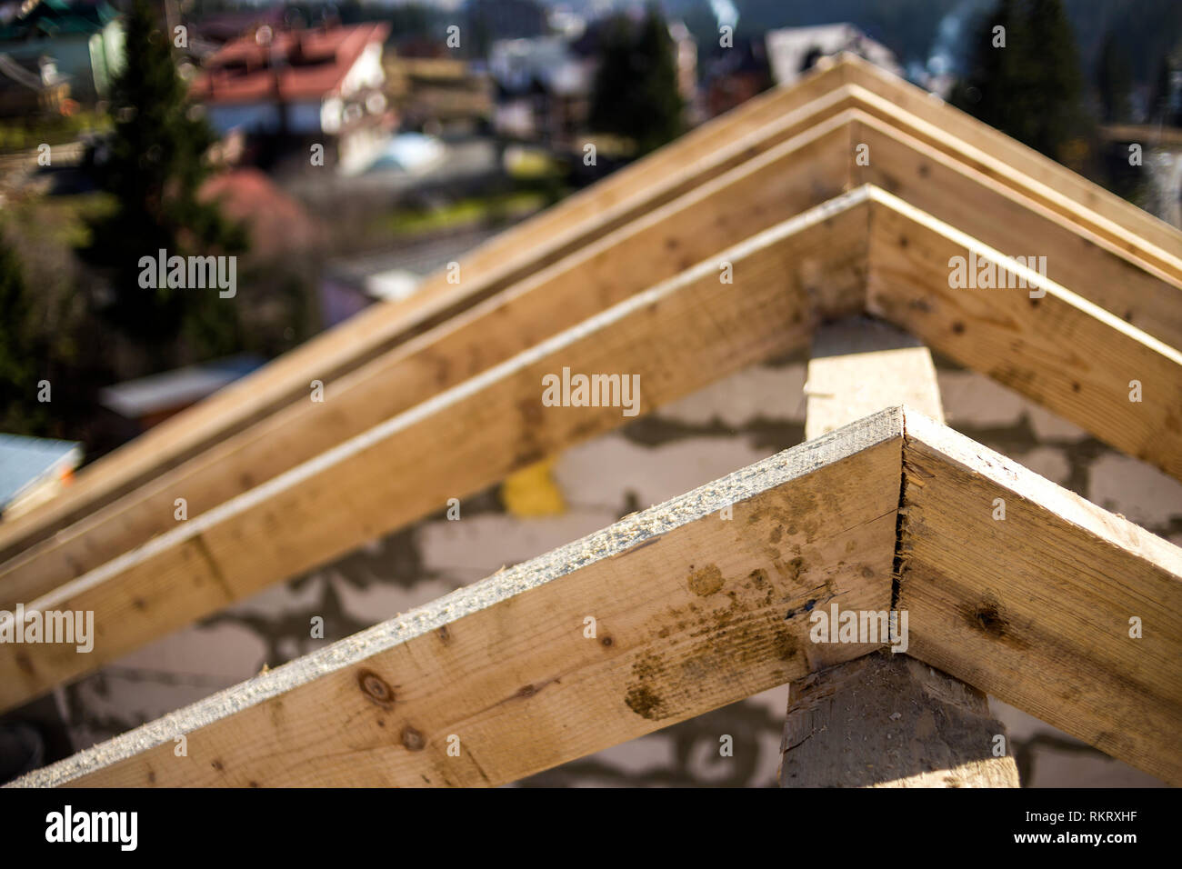 Close-up detail of roof frame of rough wooden lumber beams on ...