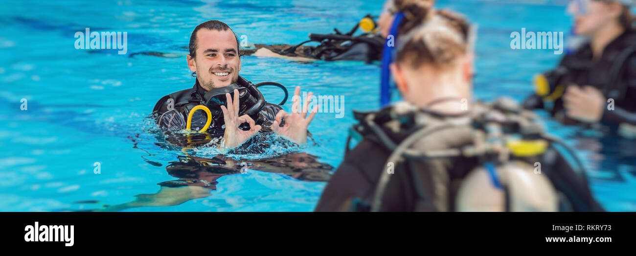 Diving instructor and students. Instructor teaches students to dive ...