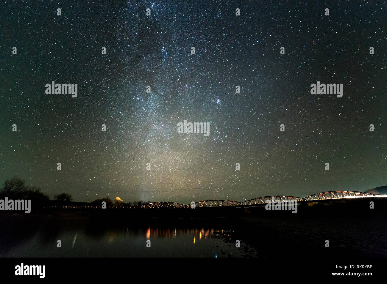 Landscape of pebbles river bank, trees on horizon, bright stars and ...
