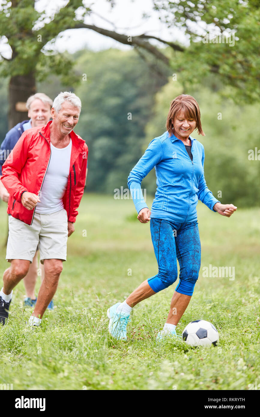 Active seniors play soccer in senior sports or at a sports festival ...