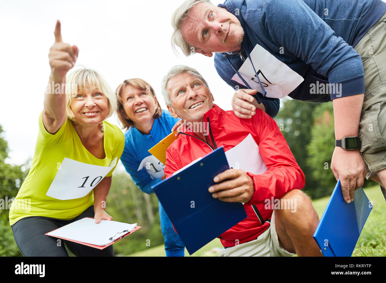 Seniors with clipboard at a geocaching game or scavenger hunt Stock ...