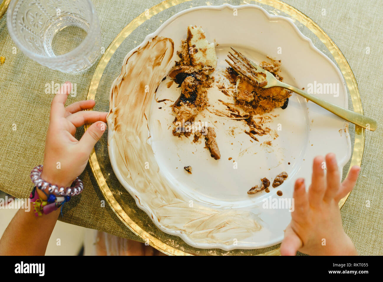 Elegant dish soiled and finished with child's hands finishing eating ...