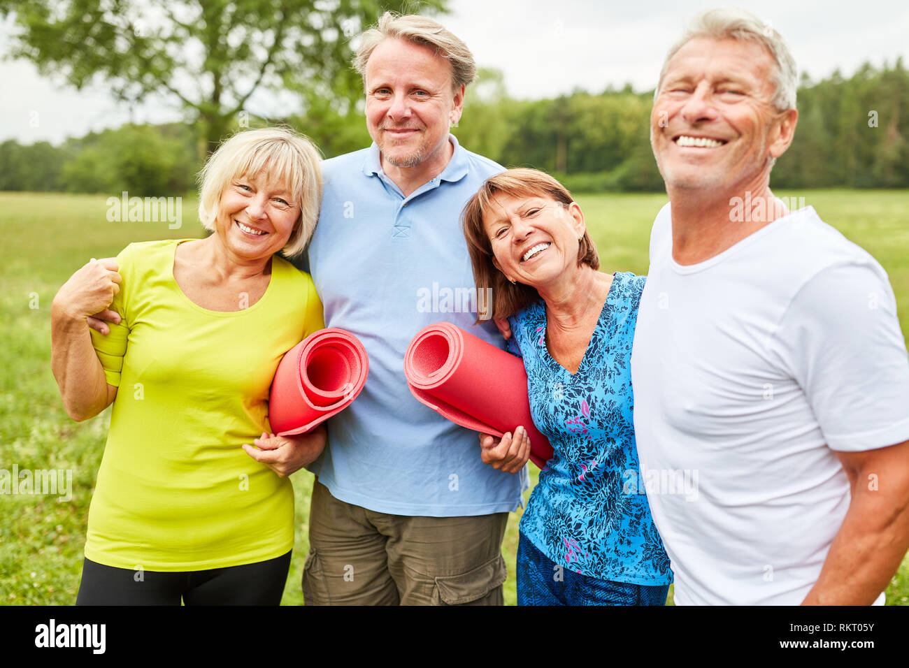 Happy seniors retired as good friends together in the park in summer ...
