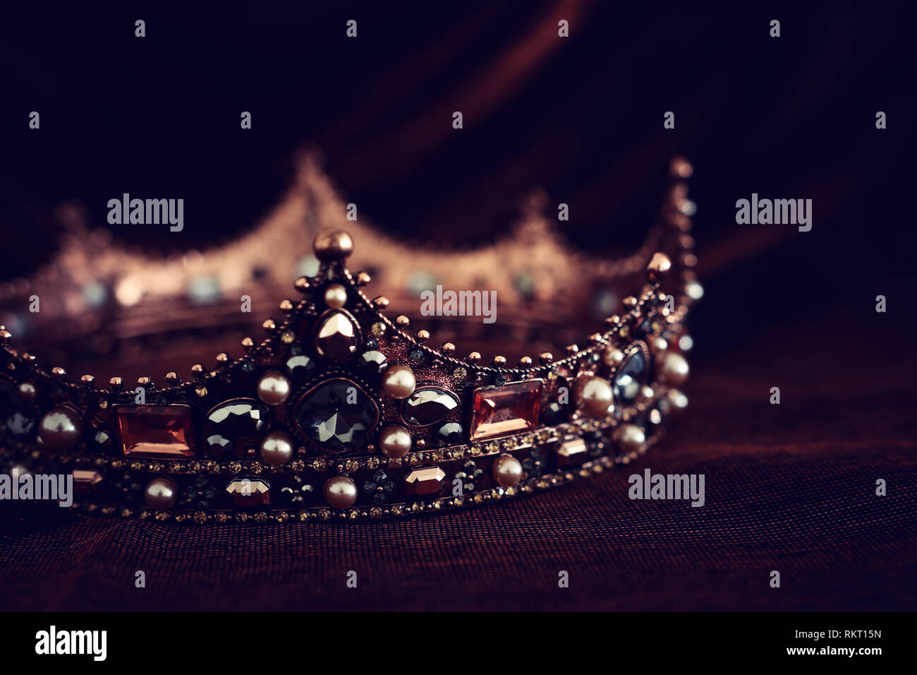 photo of gold crown over gothic dark silk background. Medieval period ...