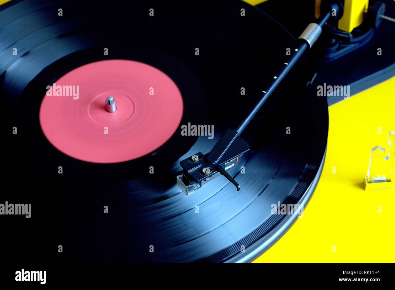 Vinyl LP record with red label sound reproduction on vintage turntable ...