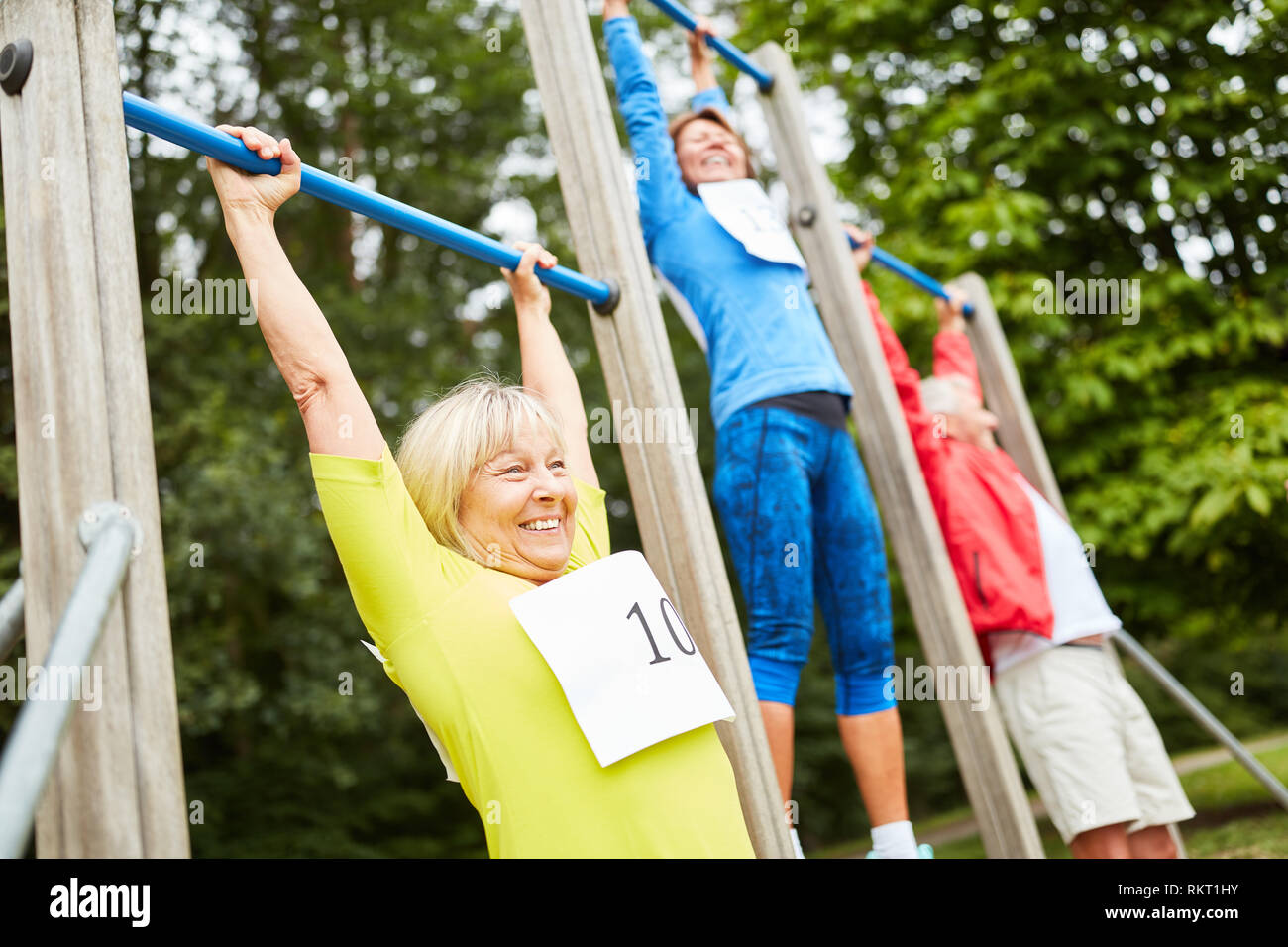 Senior group doing pull-up training on the trim you course Stock Photo ...