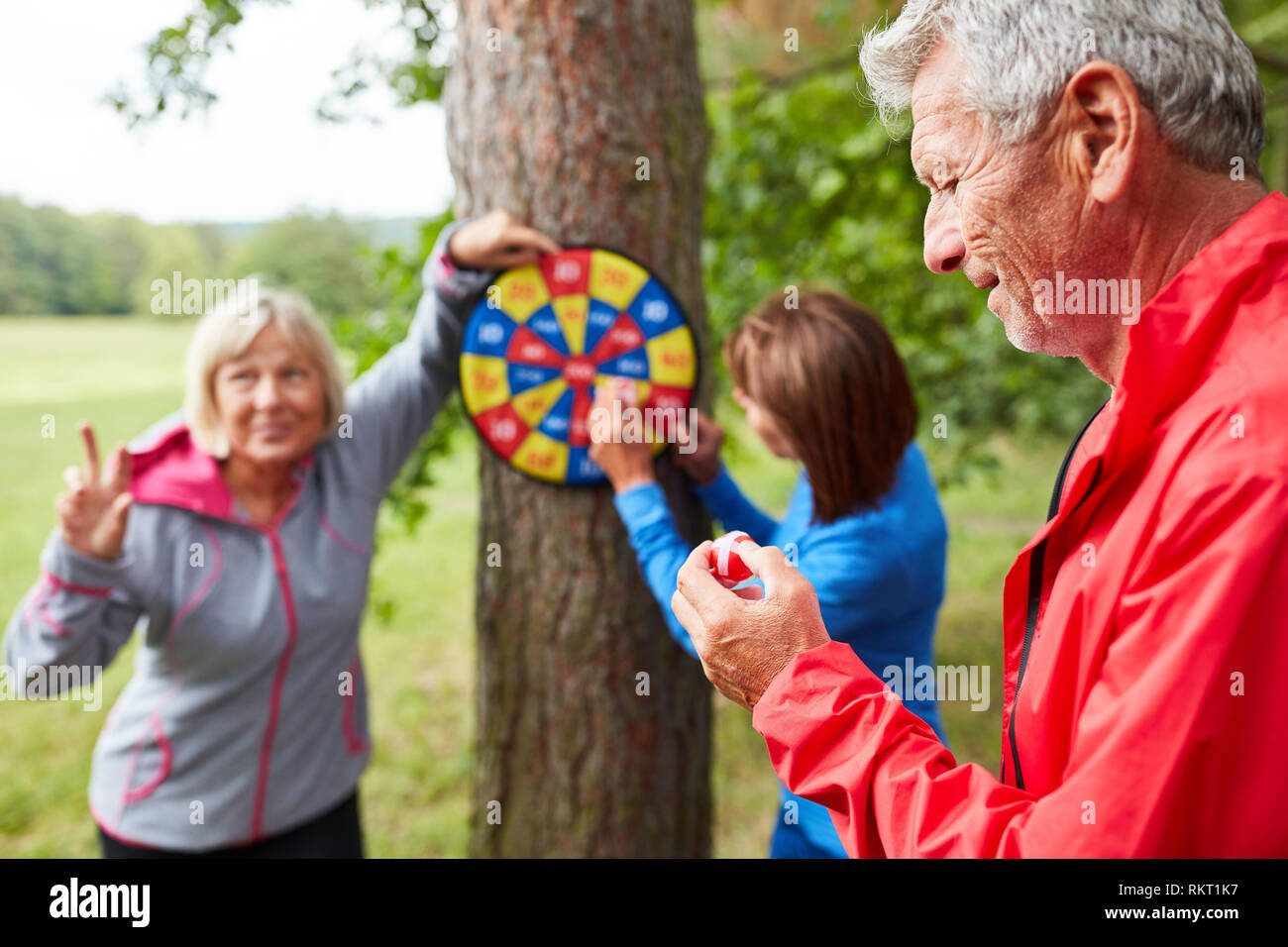 Seniors playing darts together in nature at leisure Stock Photo - Alamy