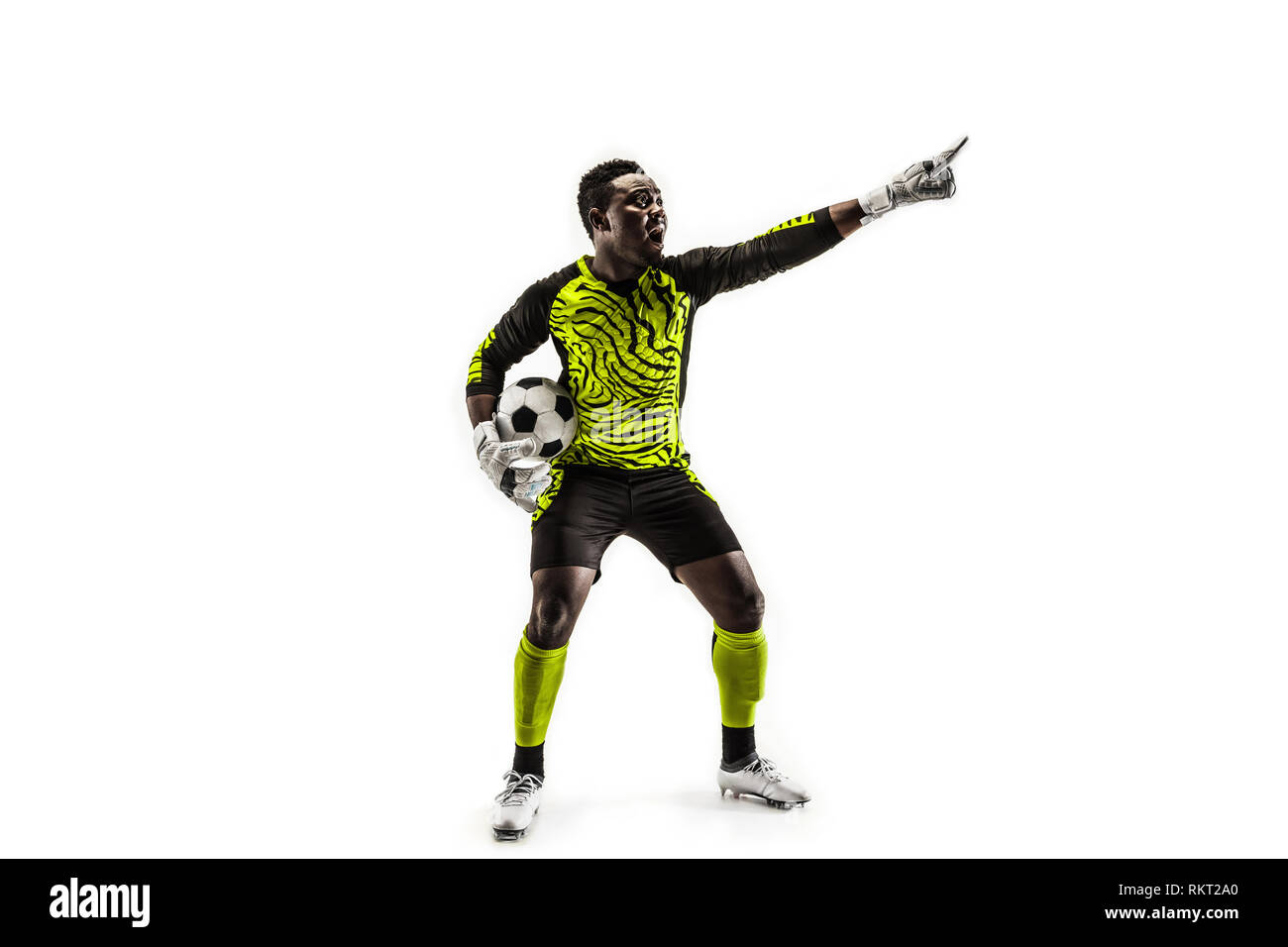 One african male soccer player goalkeeper pointing away and screaming ...
