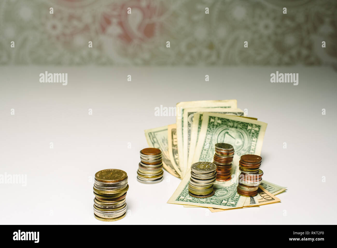 Coins and dollar bills isolated on white background with copy space ...