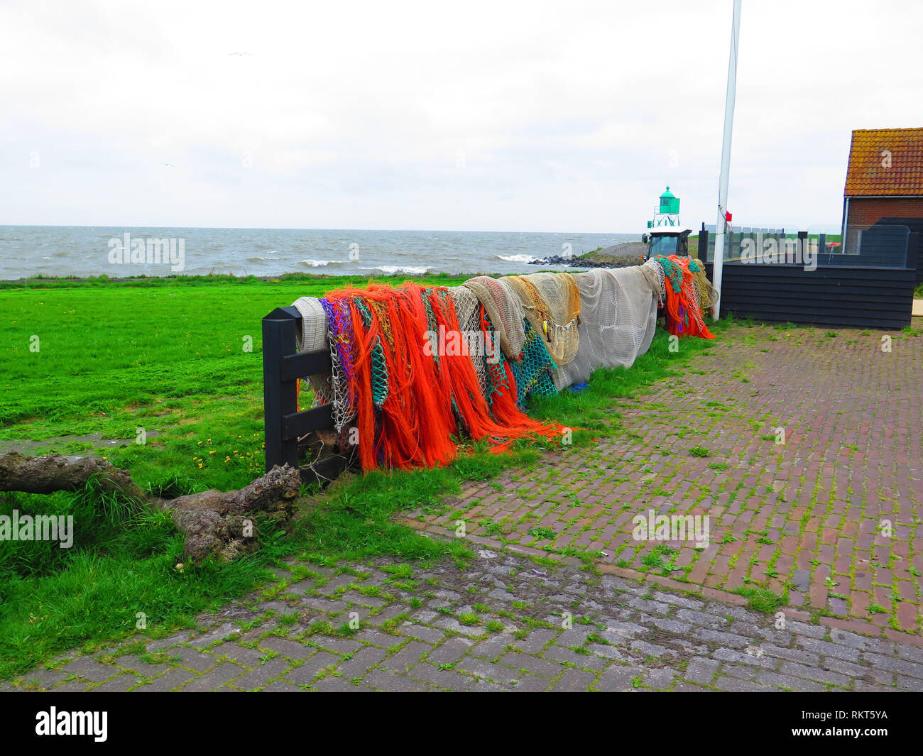 Fishing nets drying on fence in Fishing village in the Netherlands ...
