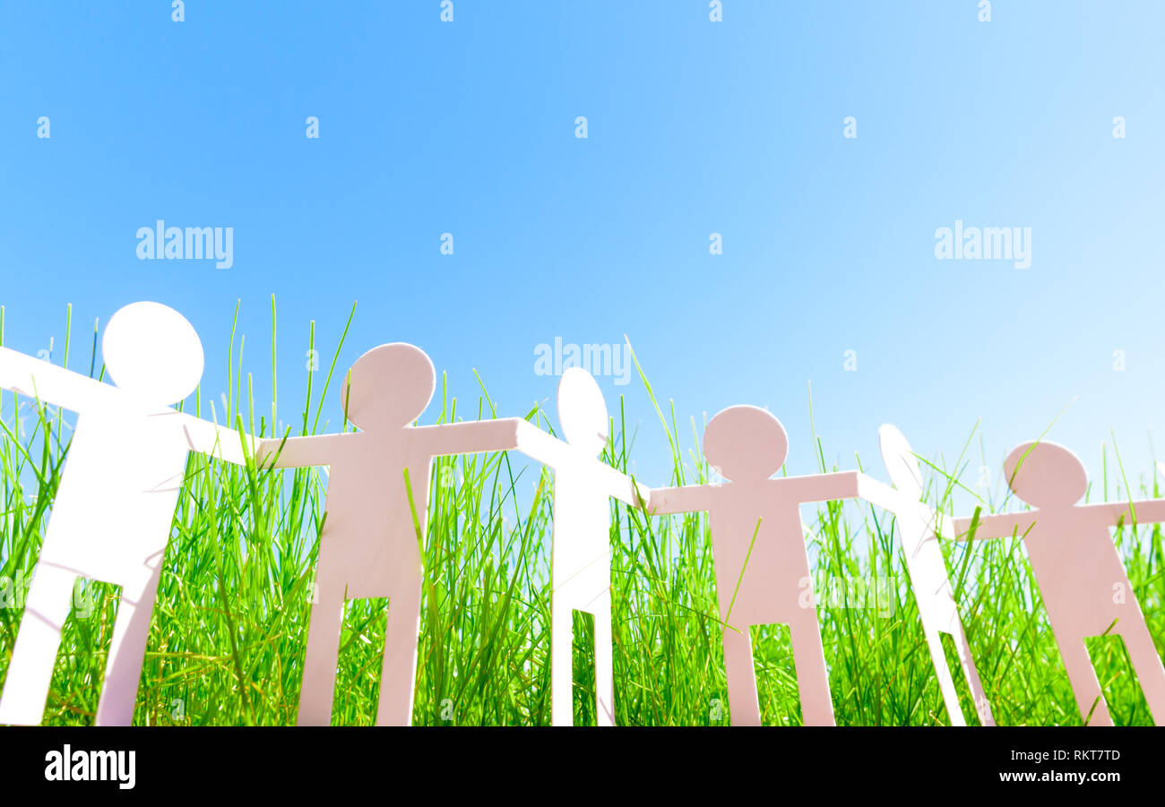 paper people chain in grass, ecology and teamwork concept Stock Photo ...