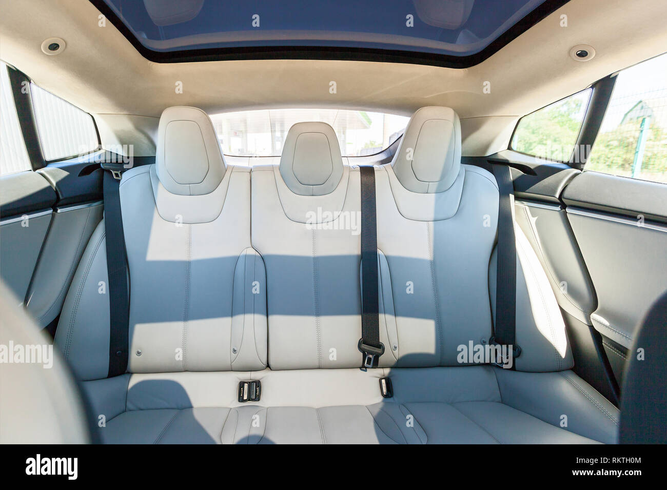 Back passenger seats in modern luxury car, frontal view, white leather ...