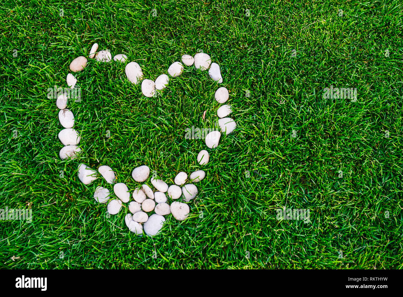 Heart of stones on green grass. Heart-shaped stones on grass Stock ...