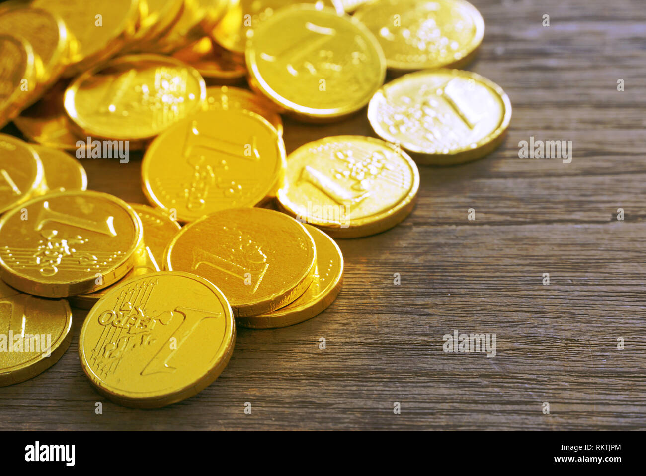 Gold coin on wood table Stock Photo - Alamy