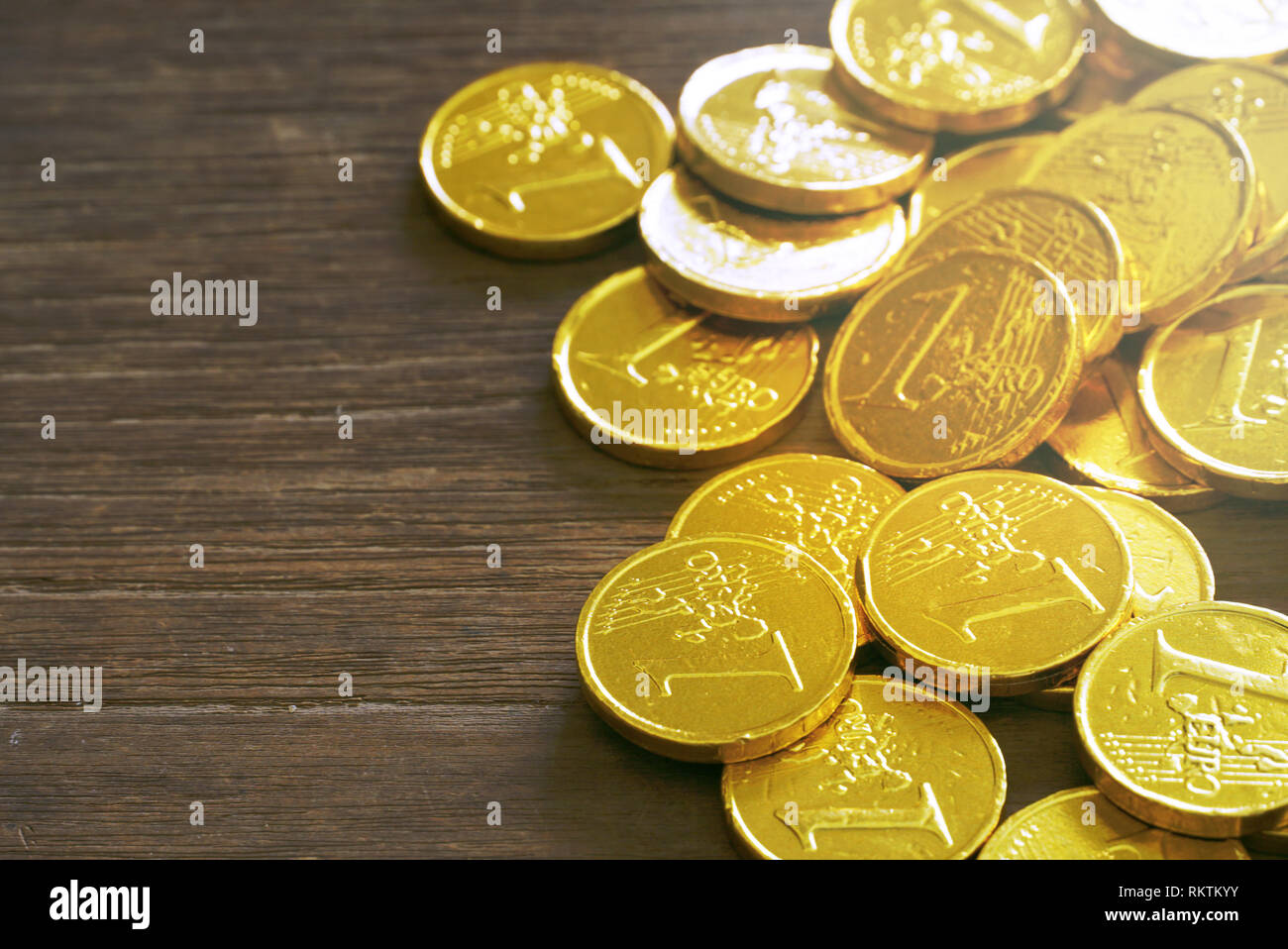 Gold coin on wood table Stock Photo - Alamy