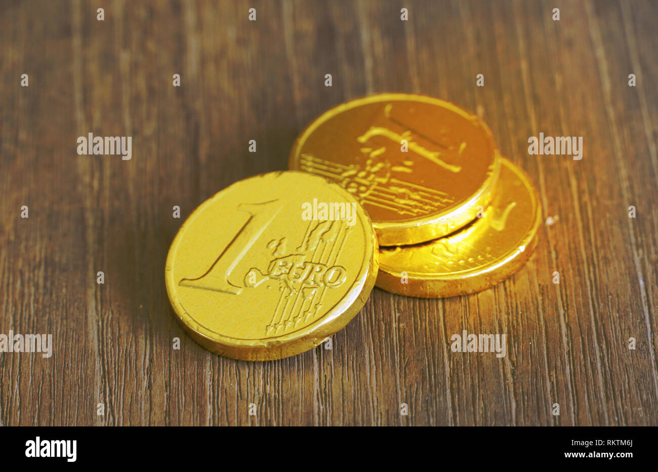 Gold coin on wood table Stock Photo - Alamy