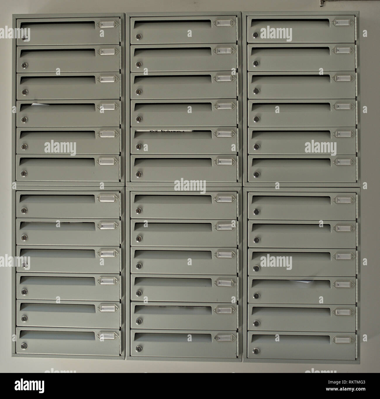 Rows of Mail Boxes in Building on white Wall Stock Photo - Alamy