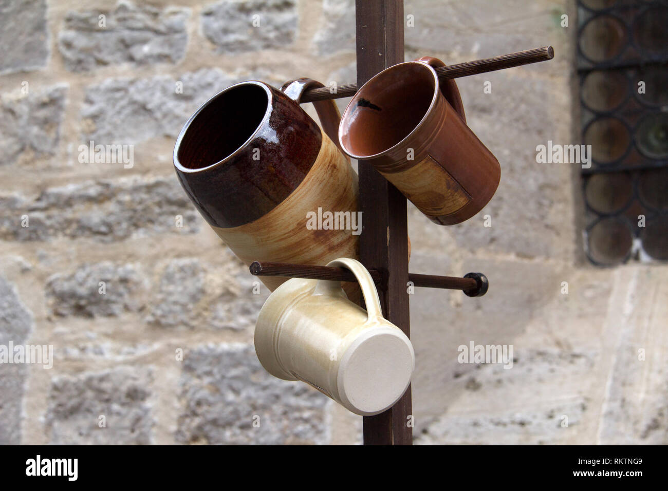 Ceramic mugs / Ceramic ware hanging on the hanger Stock Photo - Alamy