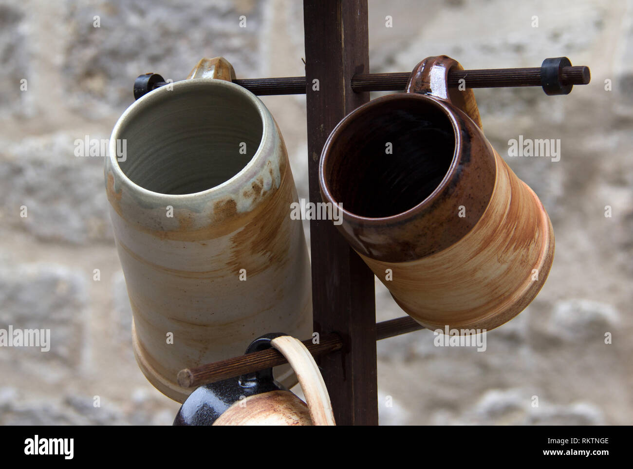 Ceramic mugs / Ceramic ware hanging on the hanger Stock Photo - Alamy