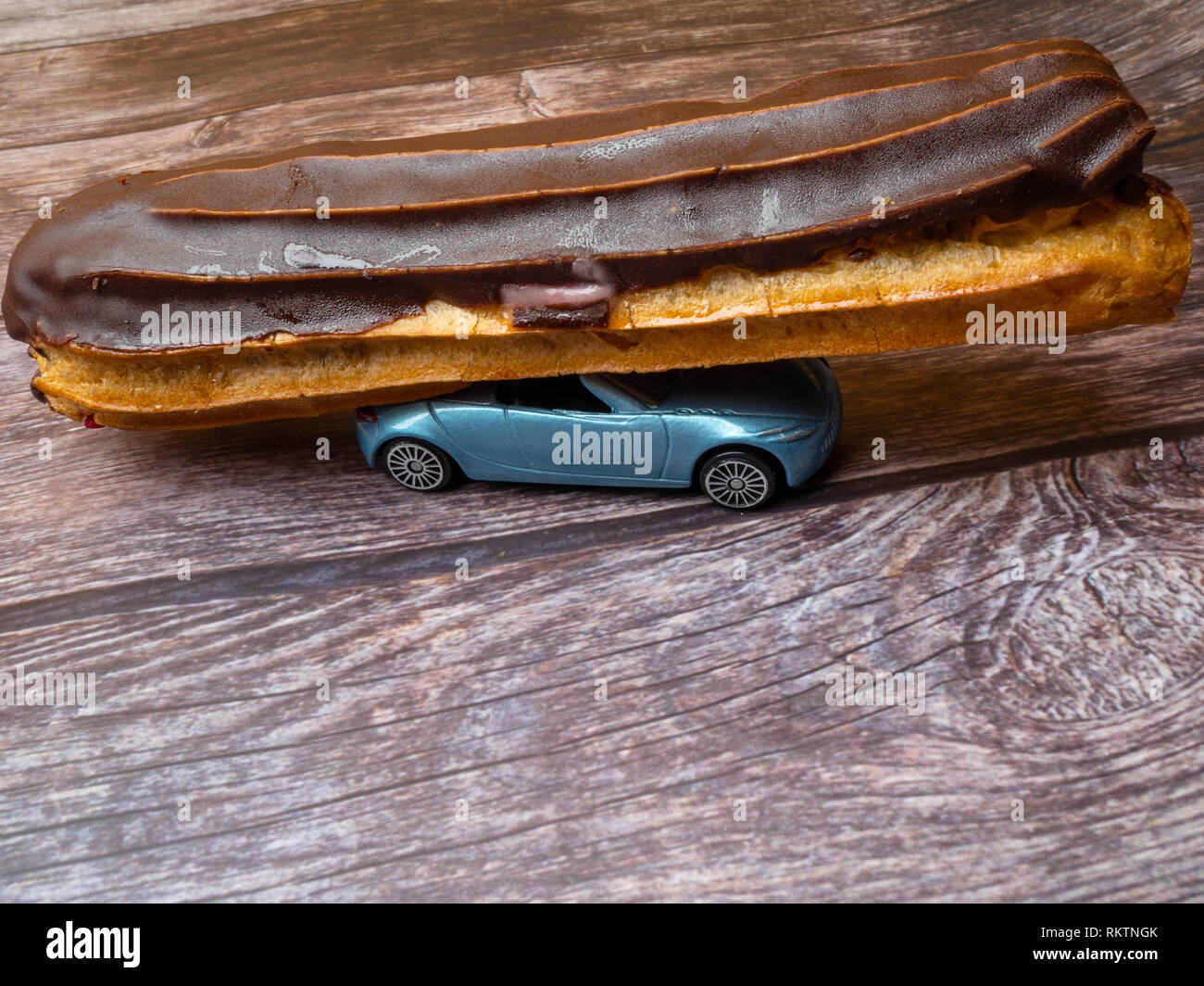 Eclair with chocolate fudge on a car, eclair order and delivery concept ...
