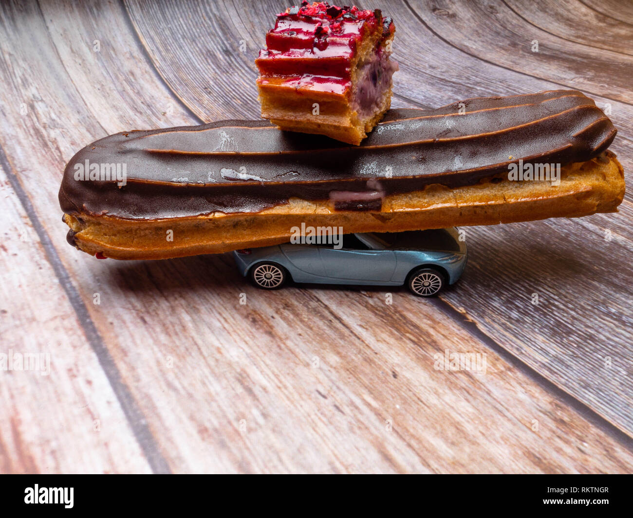 Eclair with chocolate fudge on a car, eclair order and delivery concept ...