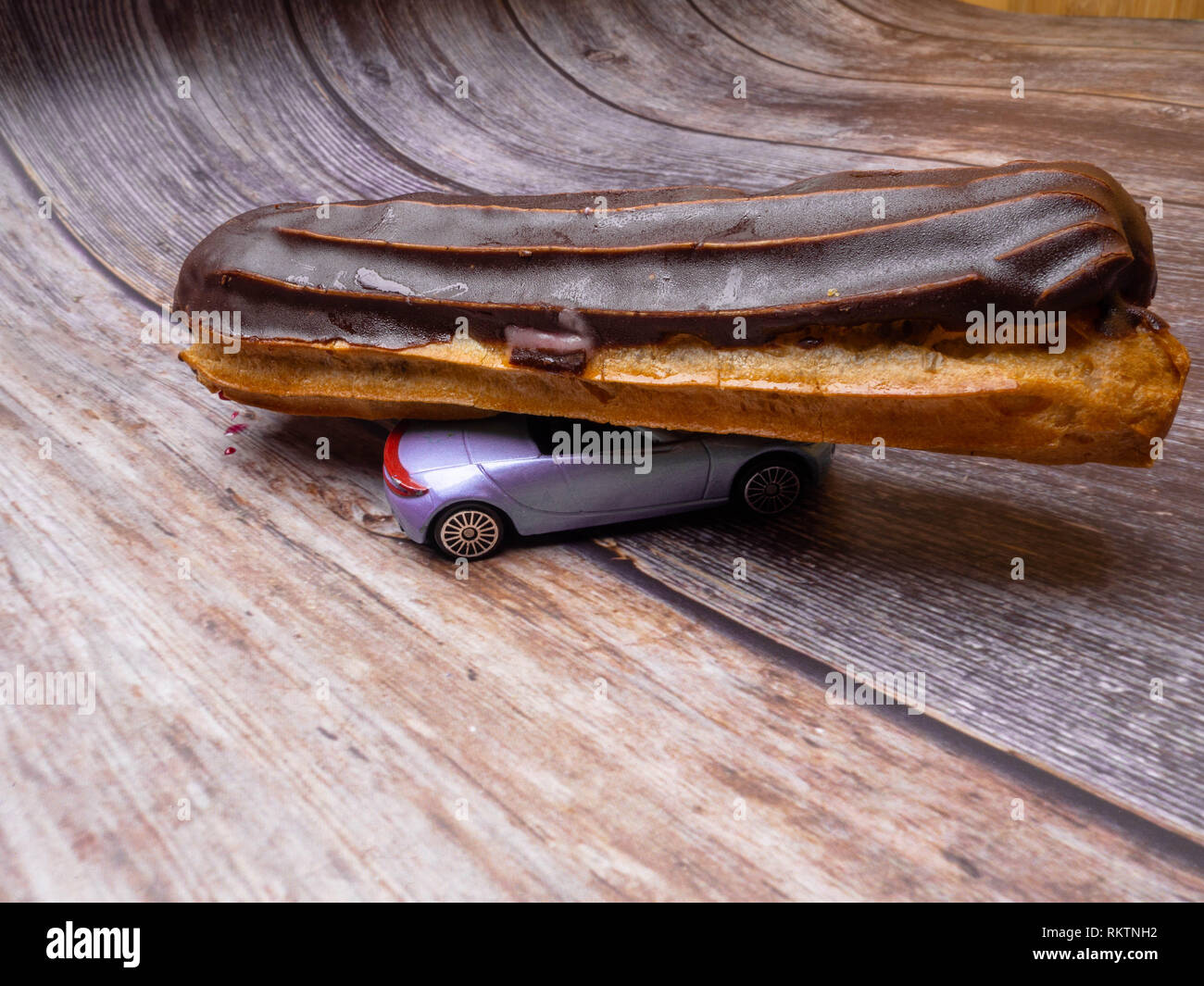 Eclair with chocolate fudge on a car, eclair order and delivery concept ...